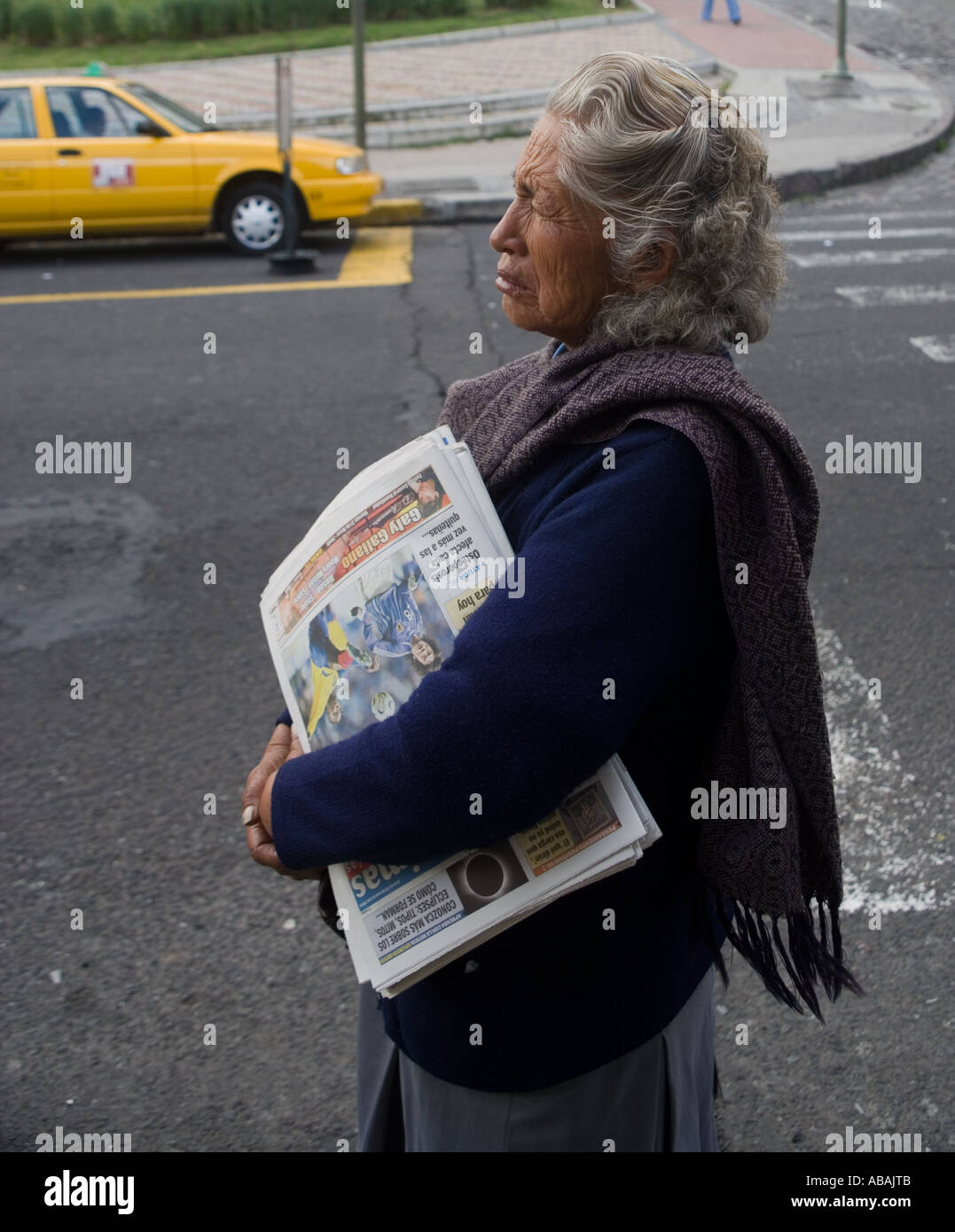 A woman selling newspapers in a street Quito Ecuador South America ...