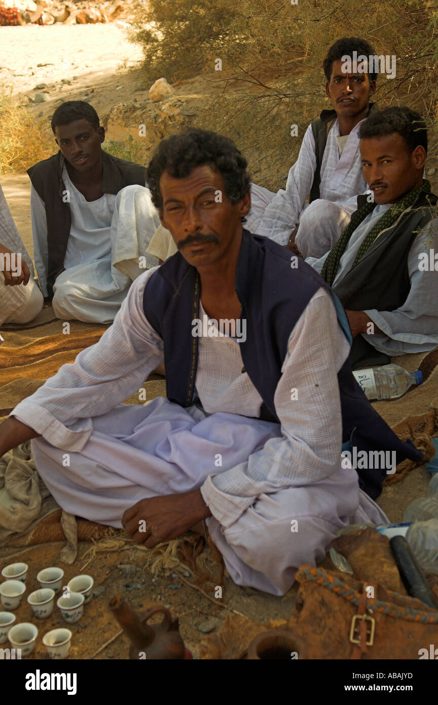 Portrait of an Ababda tribesman sharing coffee in the desert valley of ...
