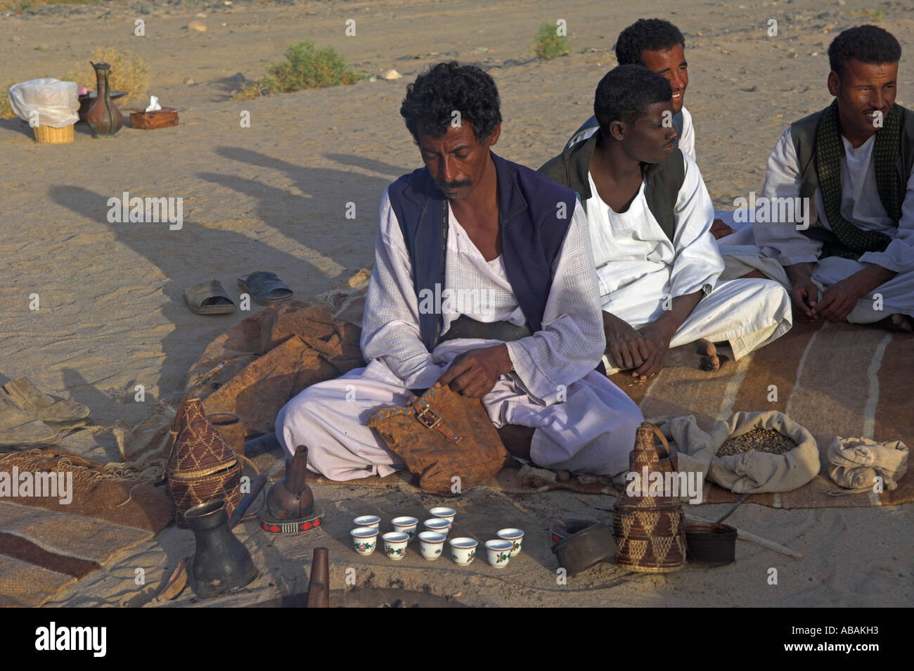 Ababda tribesman sharing early evening coffee in the desert valley of ...