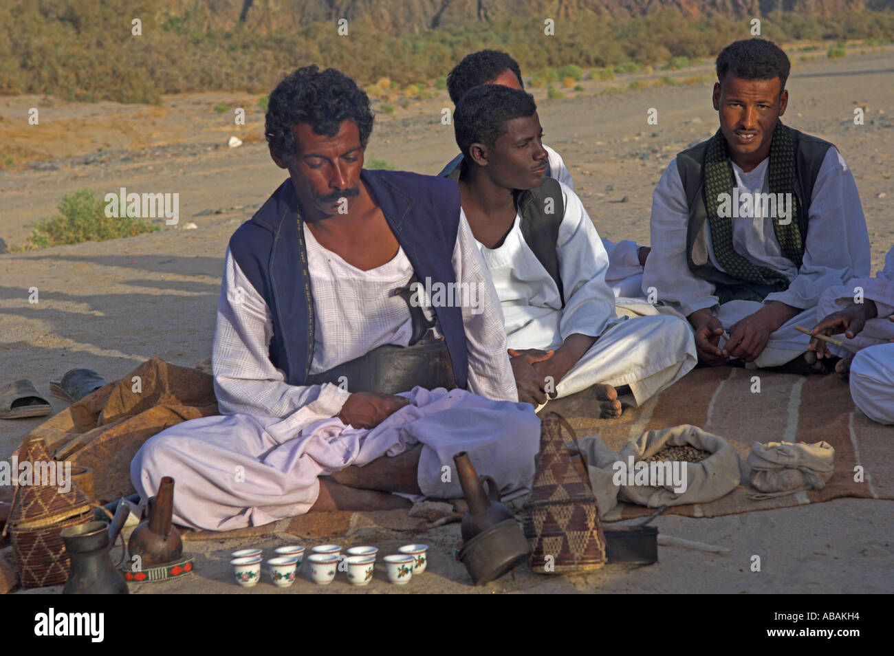 Ababda tribesman sharing coffee in the desert valley of Wadi El Gemal ...