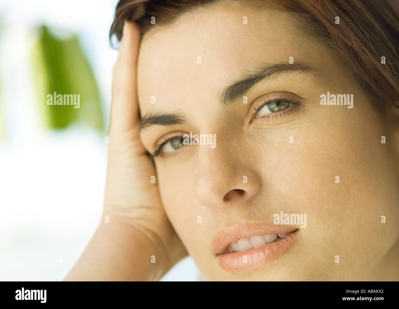 Woman leaning head on hand, close-up Stock Photo - Alamy
