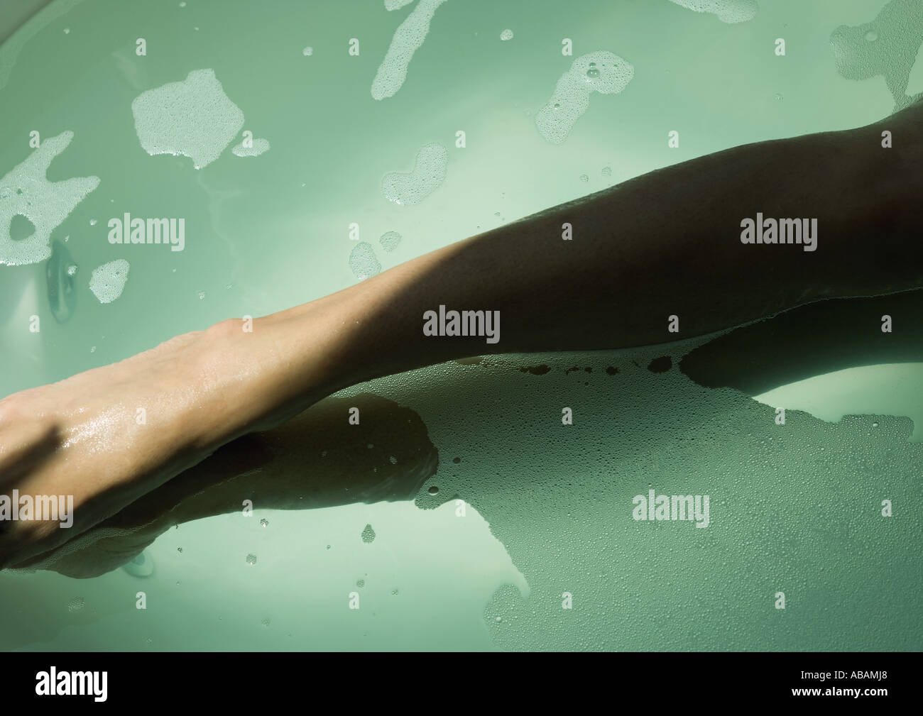 Female legs in bath water Stock Photo - Alamy
