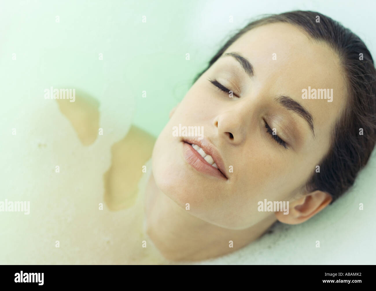 Woman reclining in bath, eyes closed Stock Photo - Alamy