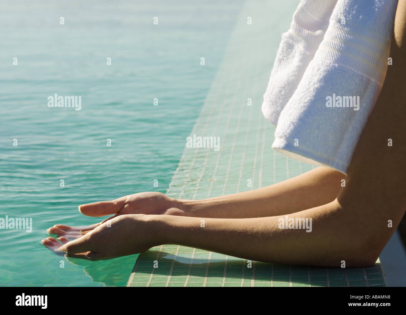 Hands cupping water at edge of pool Stock Photo - Alamy