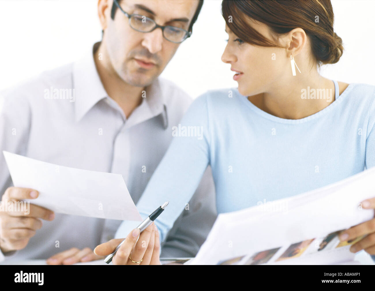 Colleagues looking at documents Stock Photo - Alamy