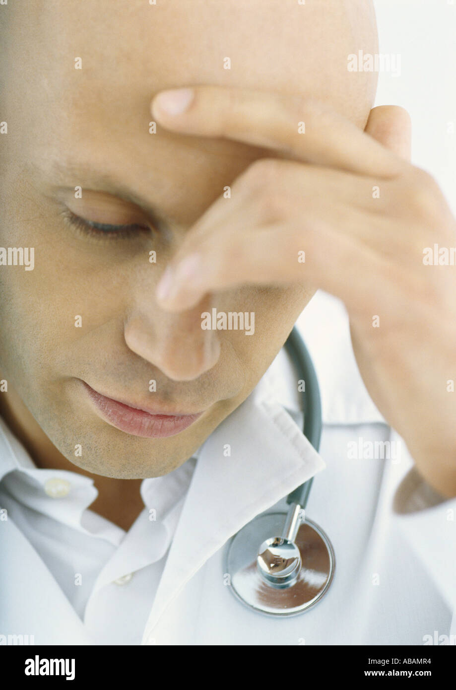 Doctor holding head looking down hi-res stock photography and images ...