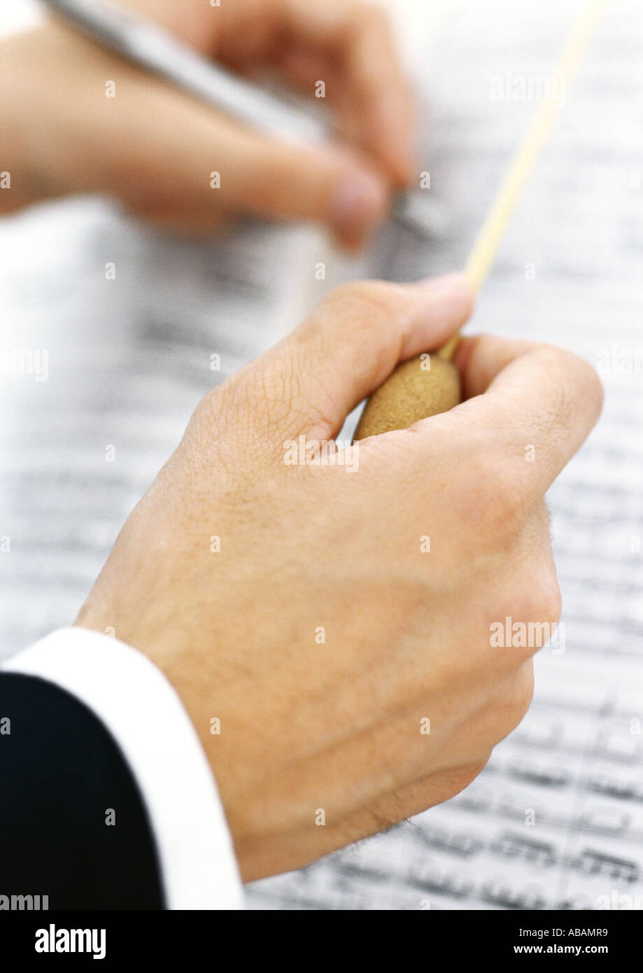 Conductor taking notes on sheet music Stock Photo - Alamy