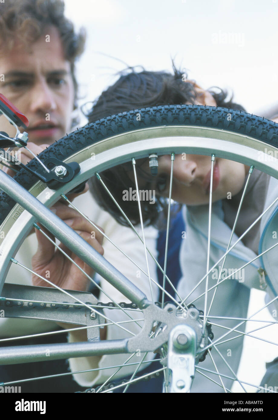 Father and son fixing bike Stock Photo - Alamy