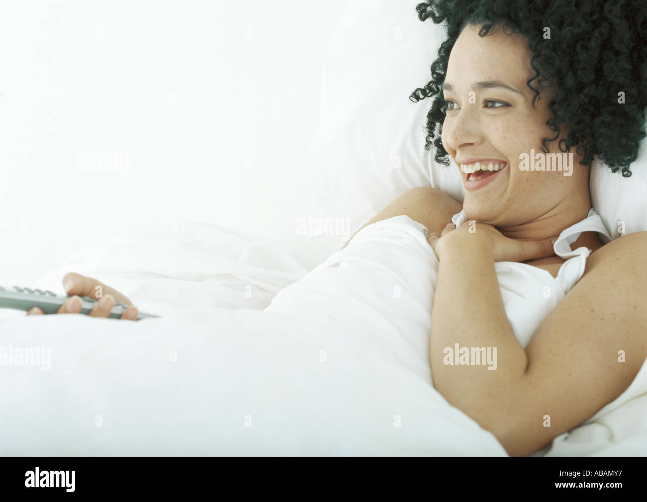Curly haired woman watching tv hi-res stock photography and images - Alamy