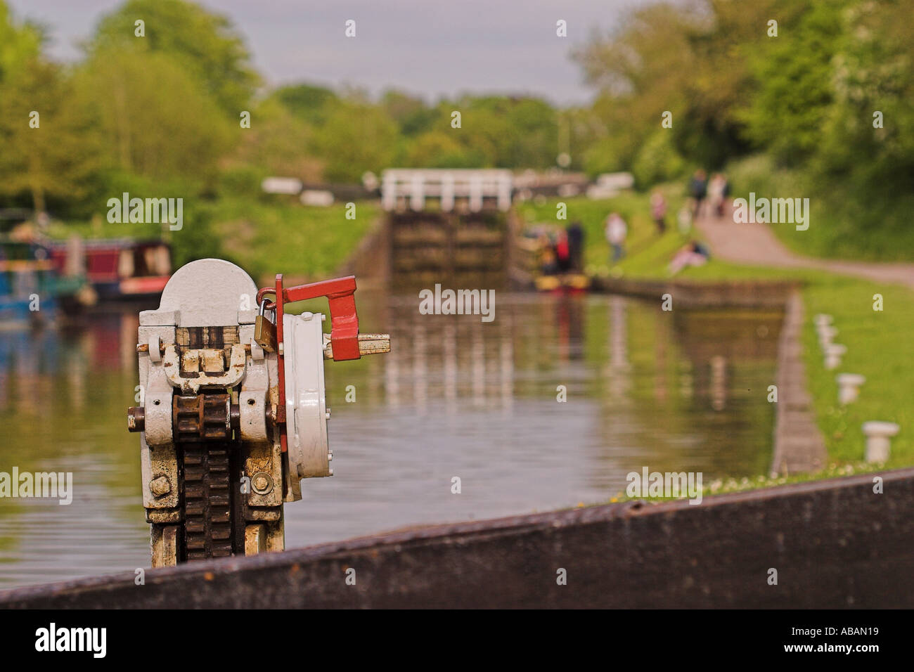 Image focusing on lock gate opening mechanism with canal and barges in ...