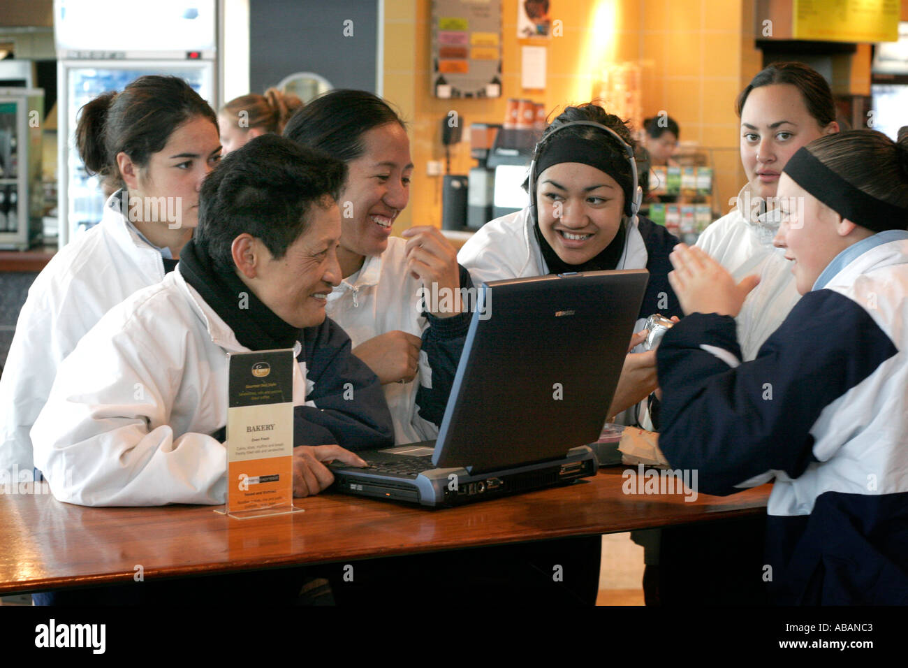 Maori girls with computer at airport lounge Stock Photo - Alamy