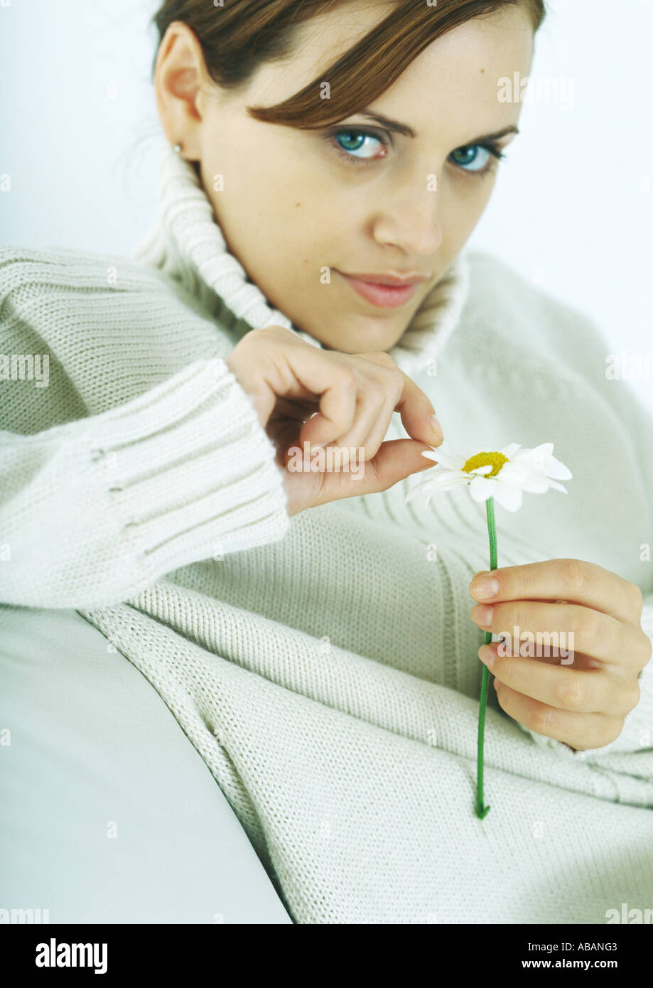 Woman plucking petal from flower Stock Photo - Alamy