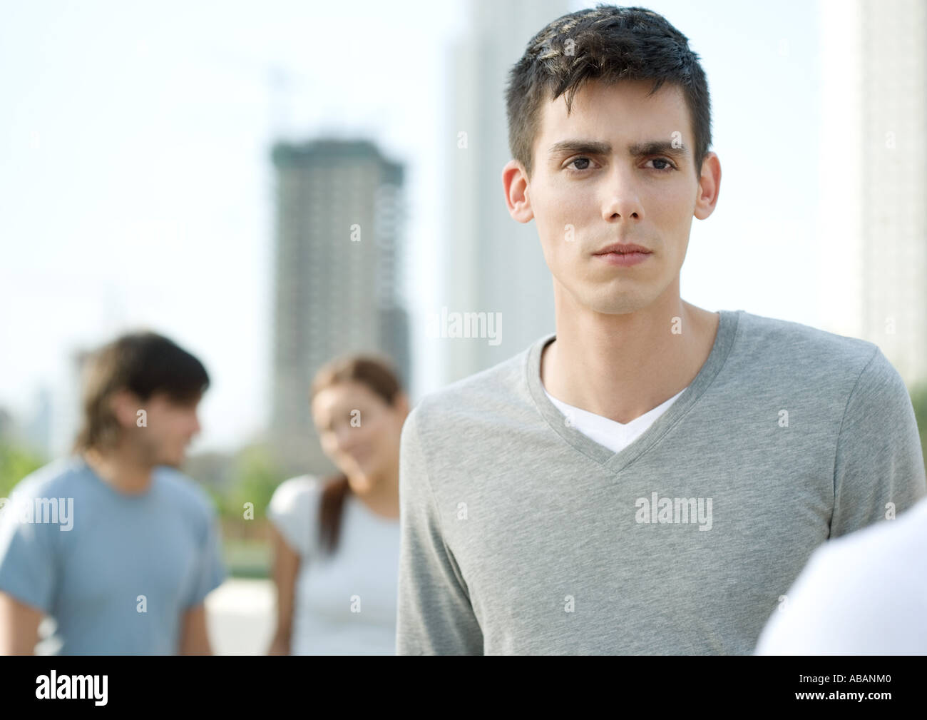 Young man with serious expression on college campus Stock Photo - Alamy