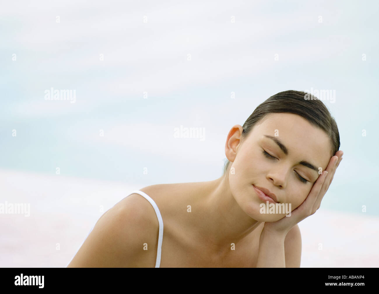 Young woman resting head on hand Stock Photo - Alamy
