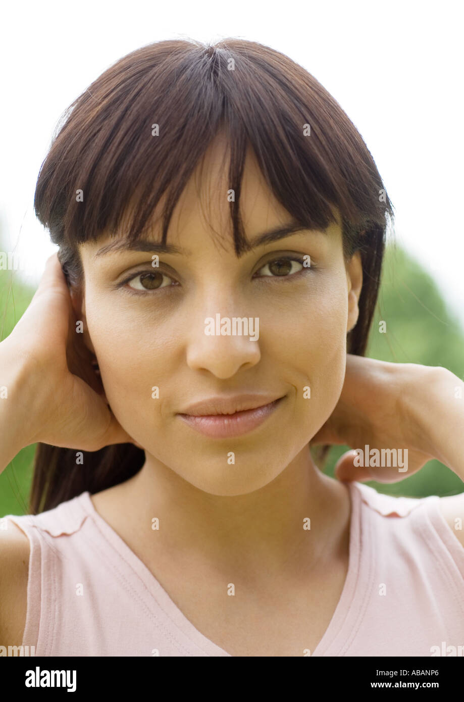Woman pushing hair back Stock Photo - Alamy