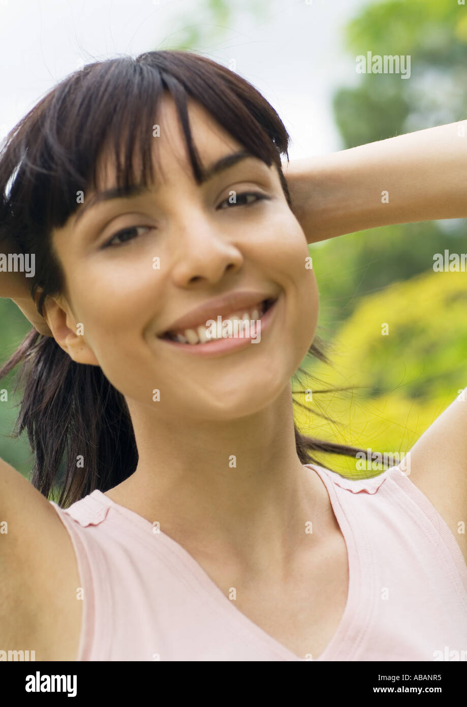 Woman holding hair back Stock Photo - Alamy