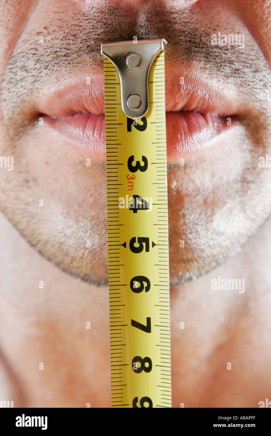 detail of mans face with tape measure over his lips Stock Photo - Alamy