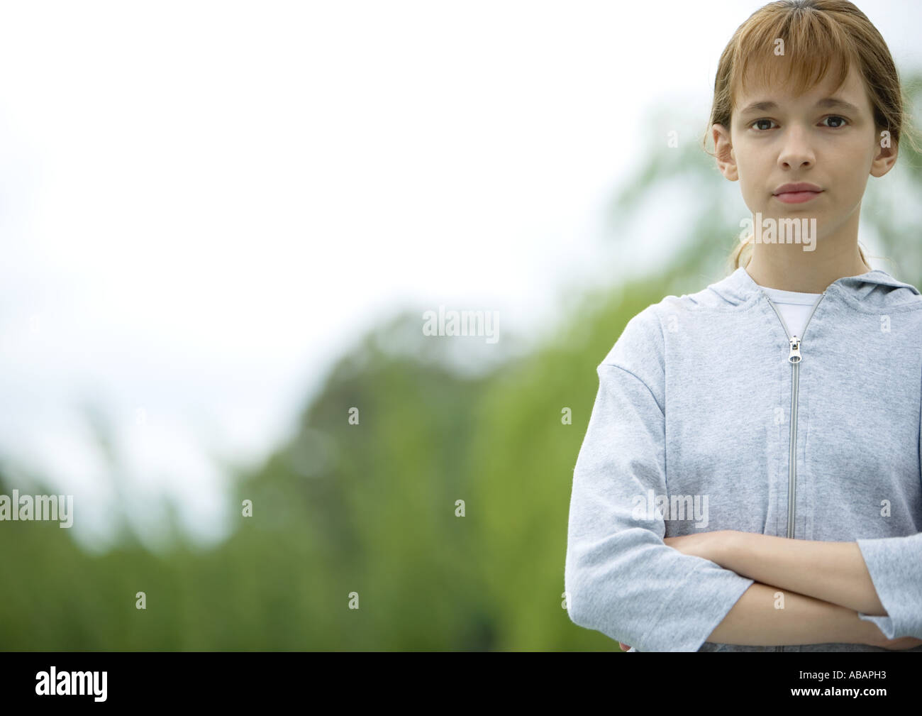 Girl with arms crossed Stock Photo - Alamy