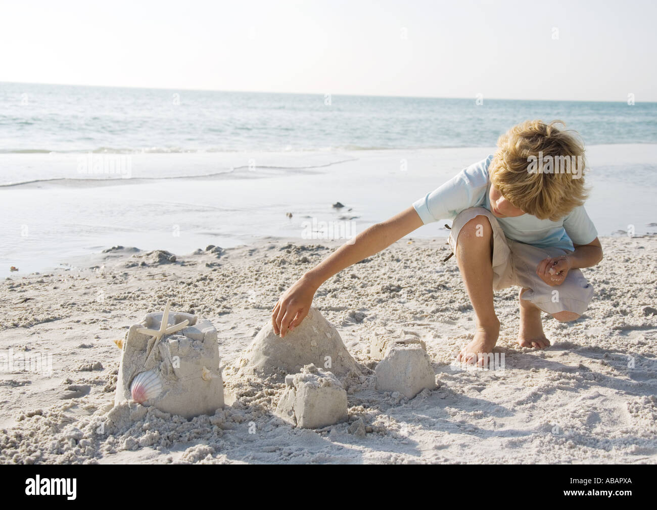 Boy building sand castle Stock Photo - Alamy