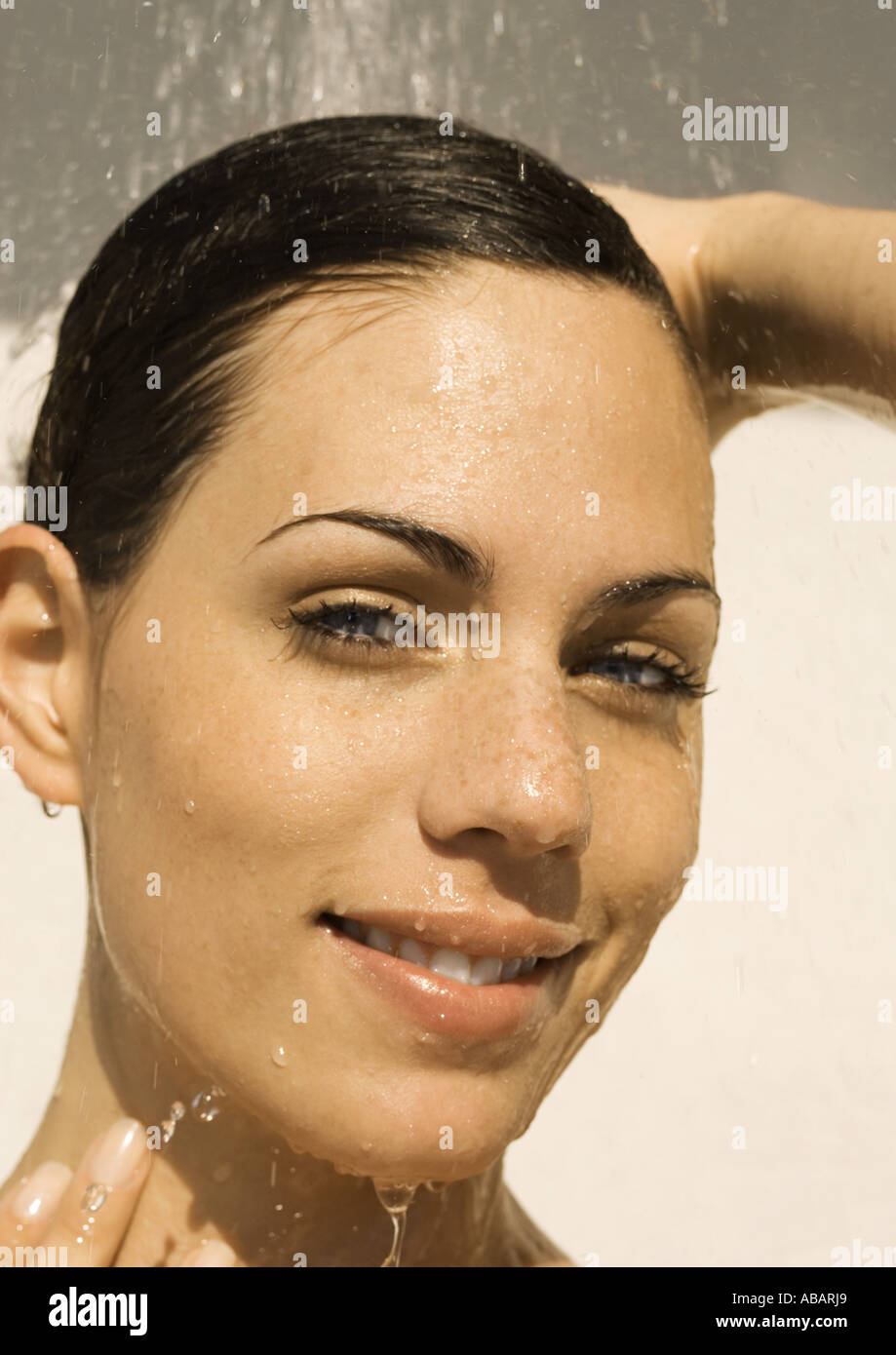 Woman's smiling face under shower Stock Photo - Alamy