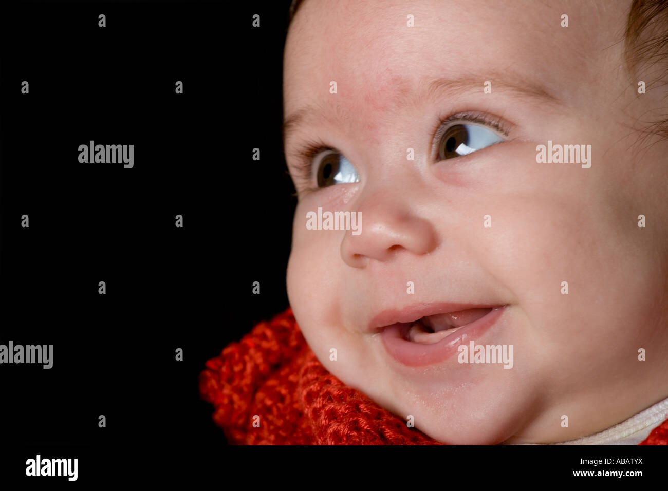Baby girl face smiling and looking to one side Stock Photo - Alamy
