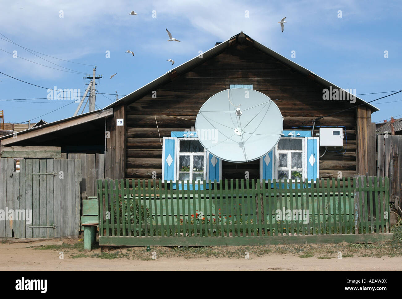 Traditional Russian izba with a satellite dish in Huzhir Village on ...