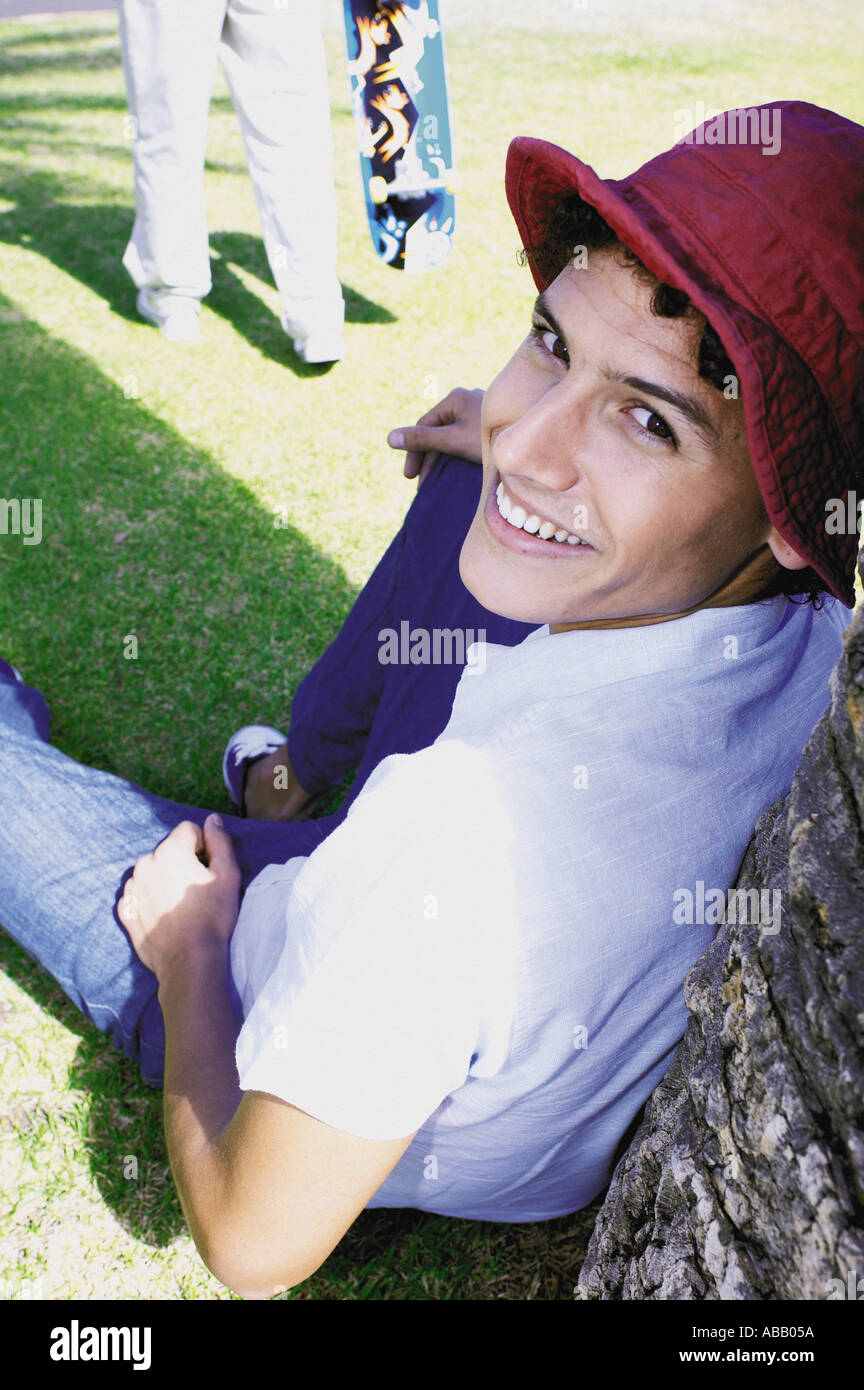 Man leaning against tree Stock Photo - Alamy