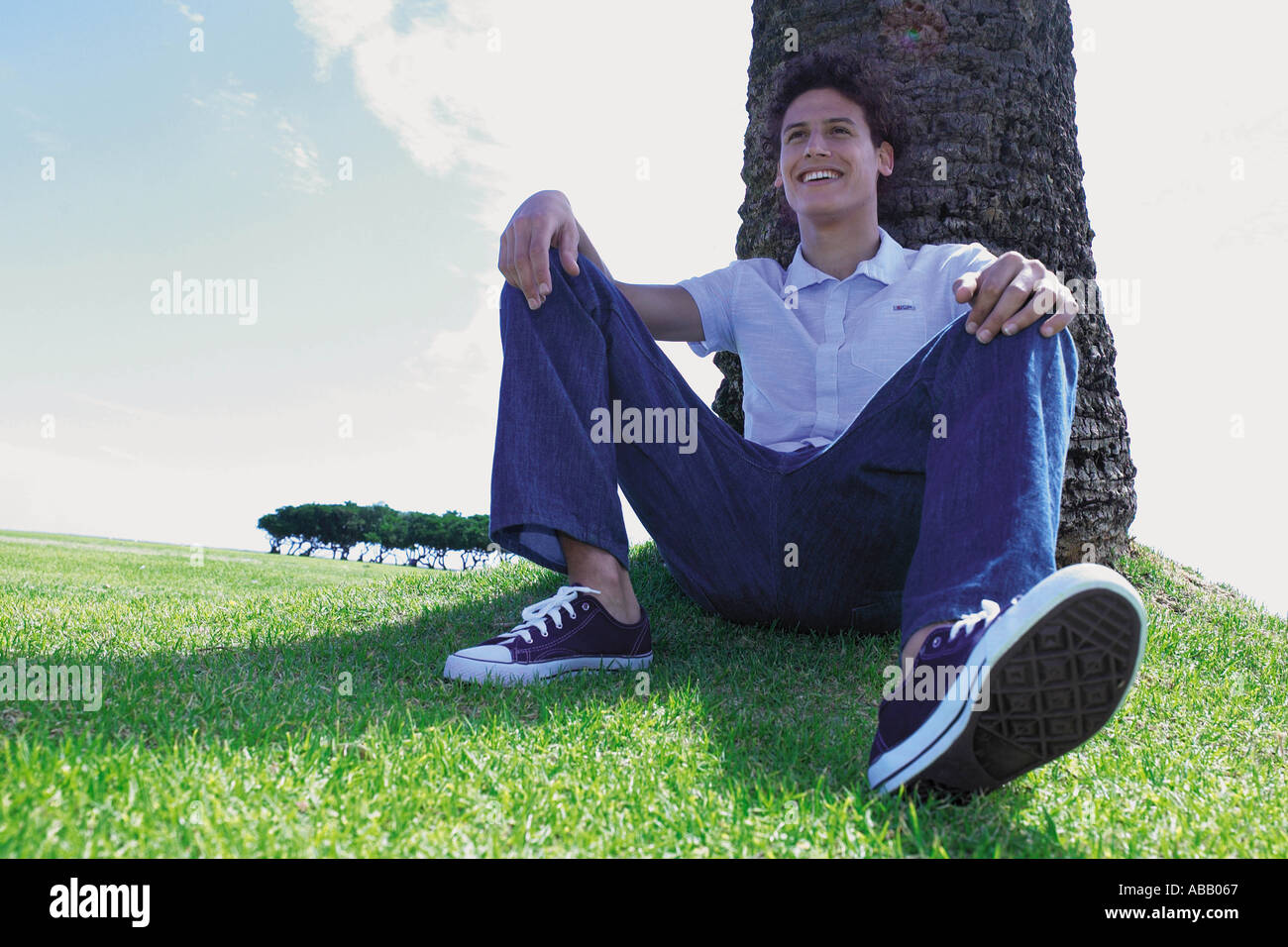 Man leaning against tree Stock Photo - Alamy