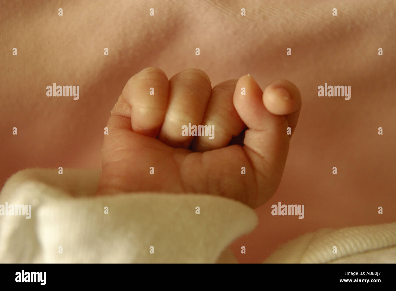 Thumb clenched hand Stock Photo - Alamy