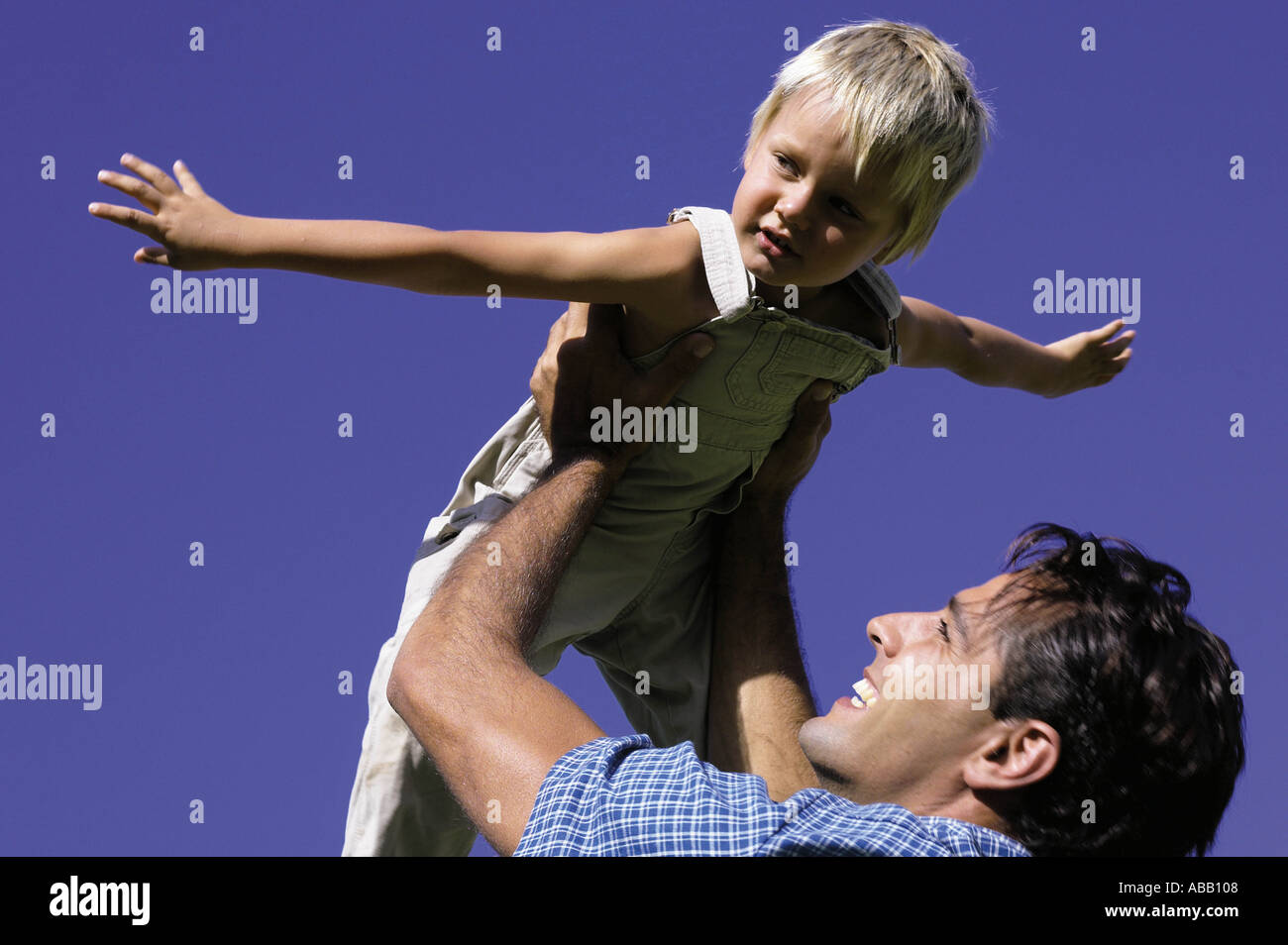 Father lifting son Stock Photo - Alamy
