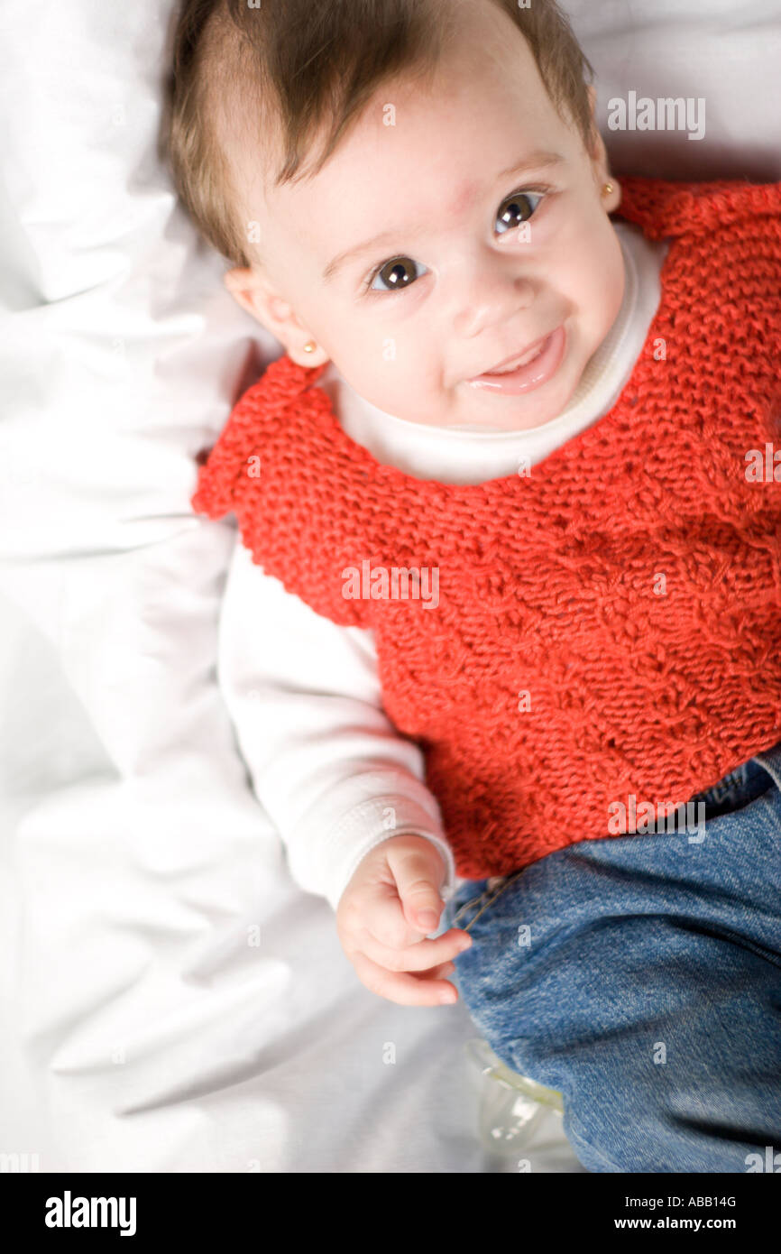 Little baby girl laid down over a white blanket and smiling Stock Photo ...
