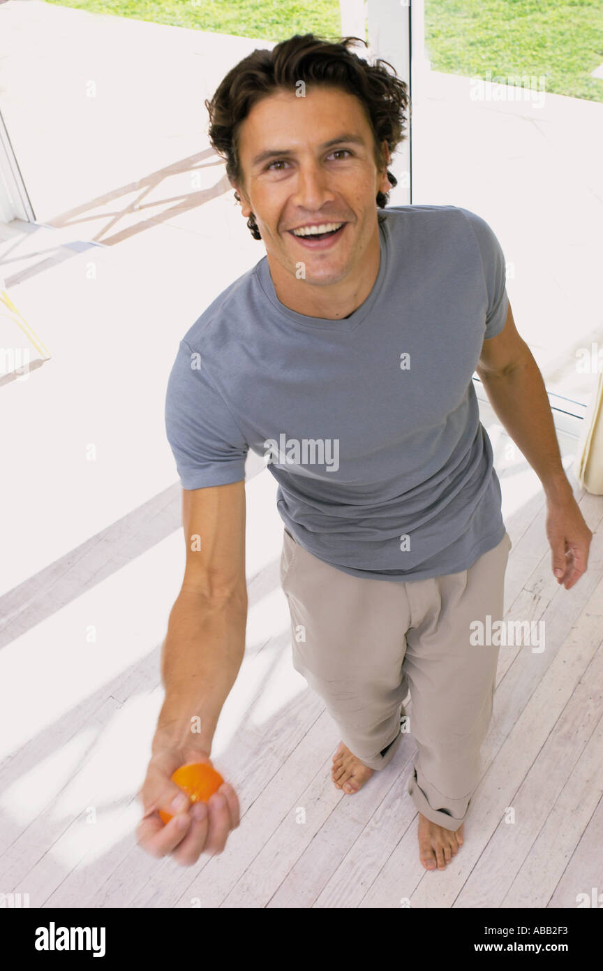Caucasian male throwing orange hi-res stock photography and images - Alamy