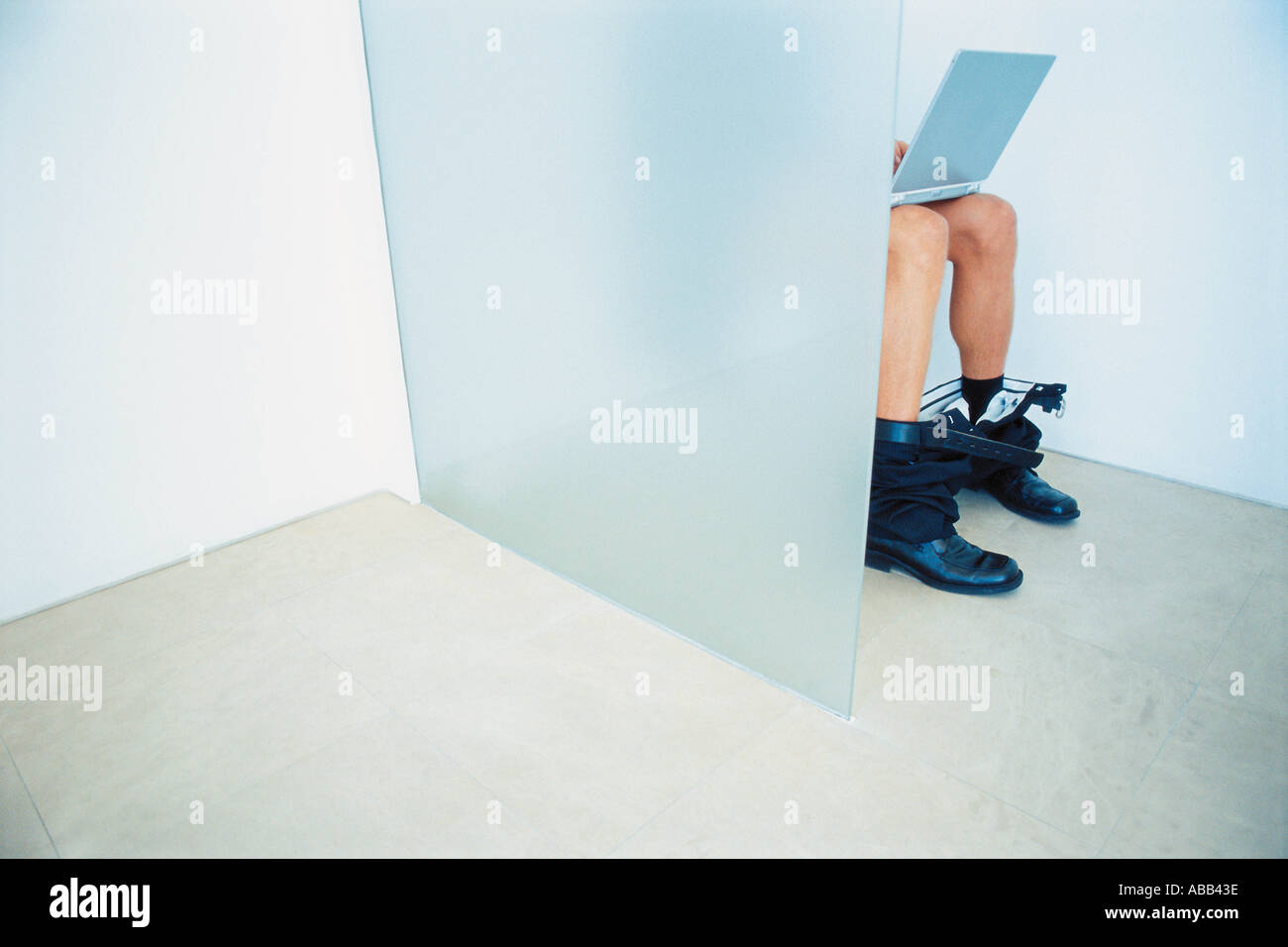 Businessman on toilet with laptop computer Stock Photo - Alamy