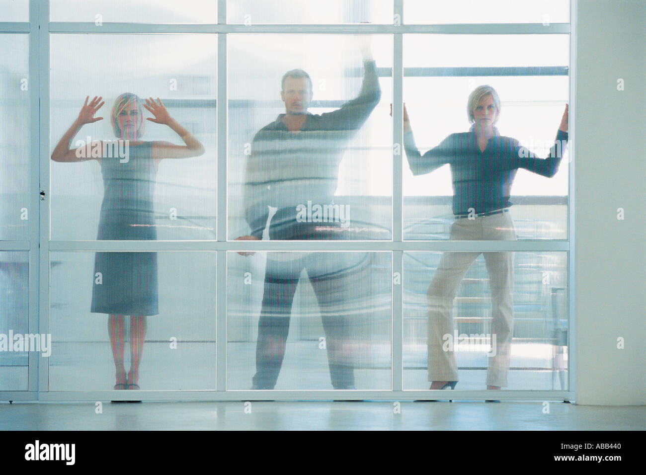 Businesspeople behind glass pane Stock Photo - Alamy
