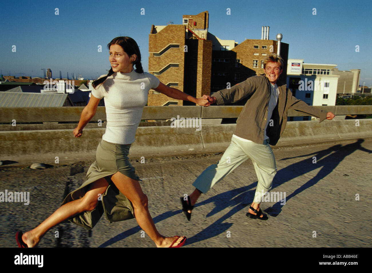 Couple running on roof Stock Photo - Alamy