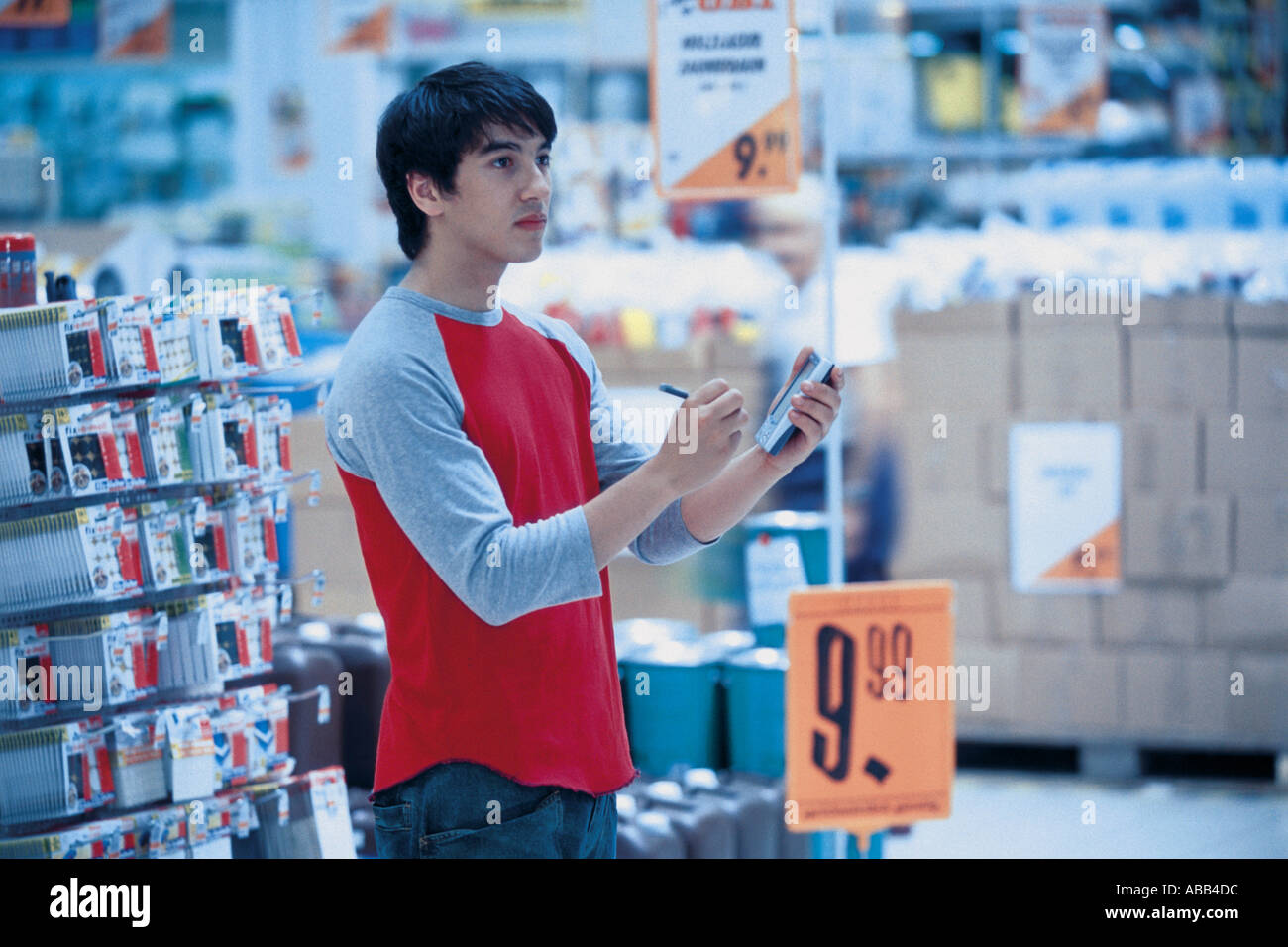 Man in using handheld computer in shop Stock Photo - Alamy