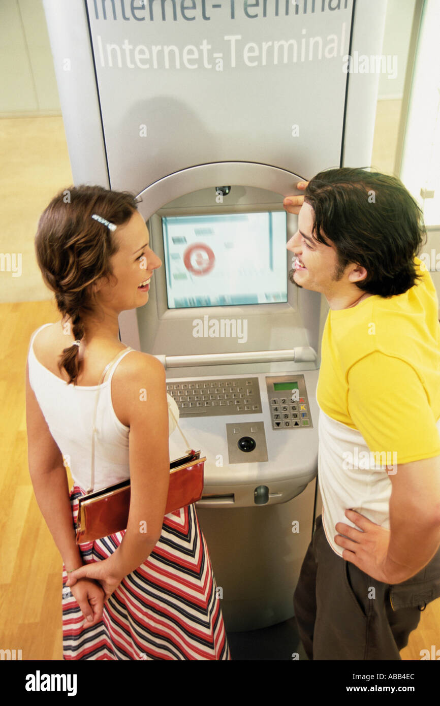 Couple at Internet terminal Stock Photo - Alamy