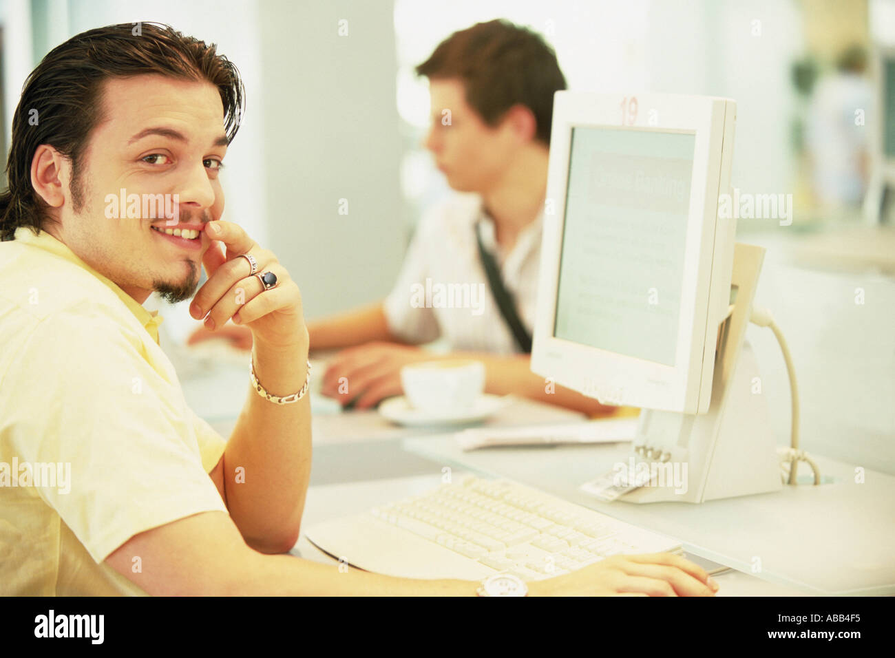 Smiling man at computer Stock Photo - Alamy