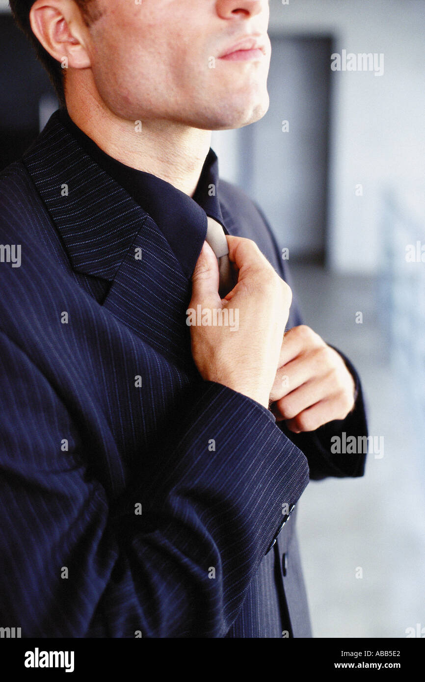 Man tying tie Stock Photo - Alamy
