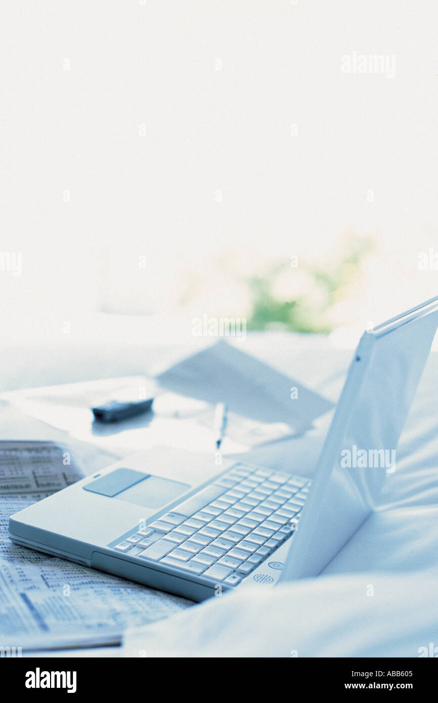 Laptop computer and cellphone on bed Stock Photo - Alamy