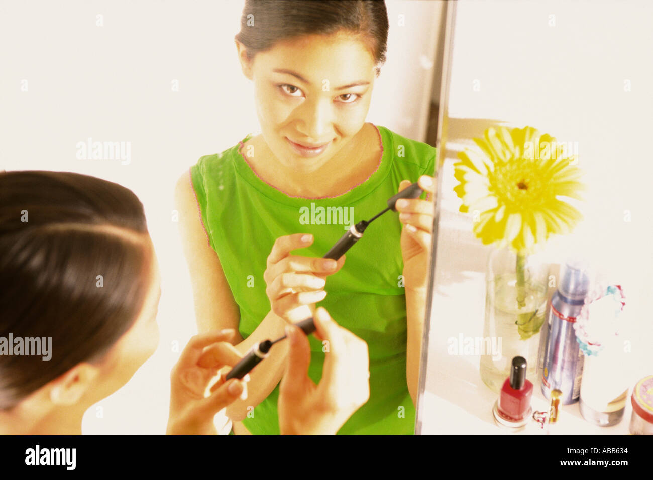 Girl holding mascara Stock Photo - Alamy