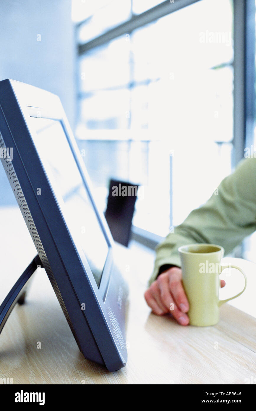 Computer and mug Stock Photo - Alamy