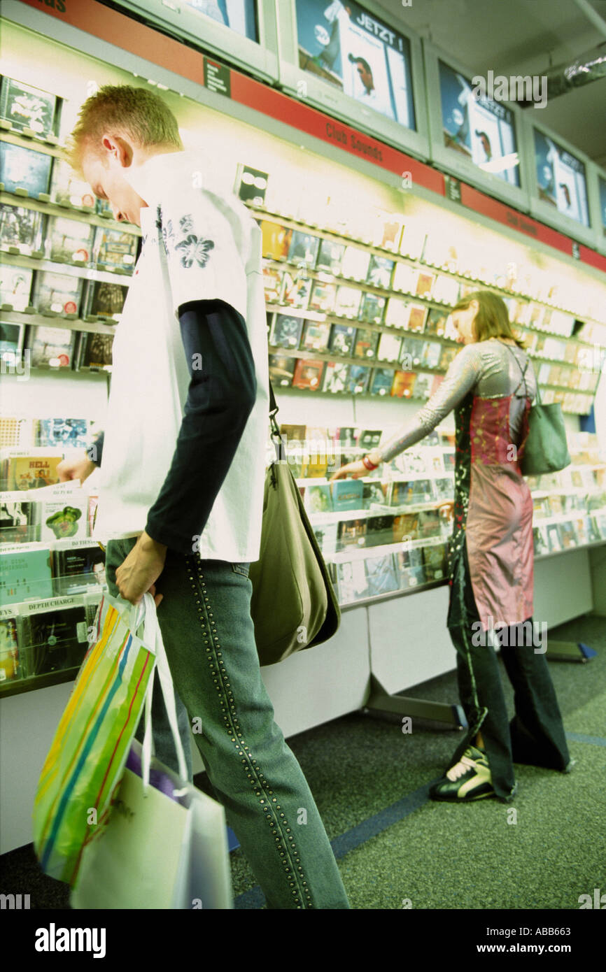 Teenagers looking at cds Stock Photo - Alamy