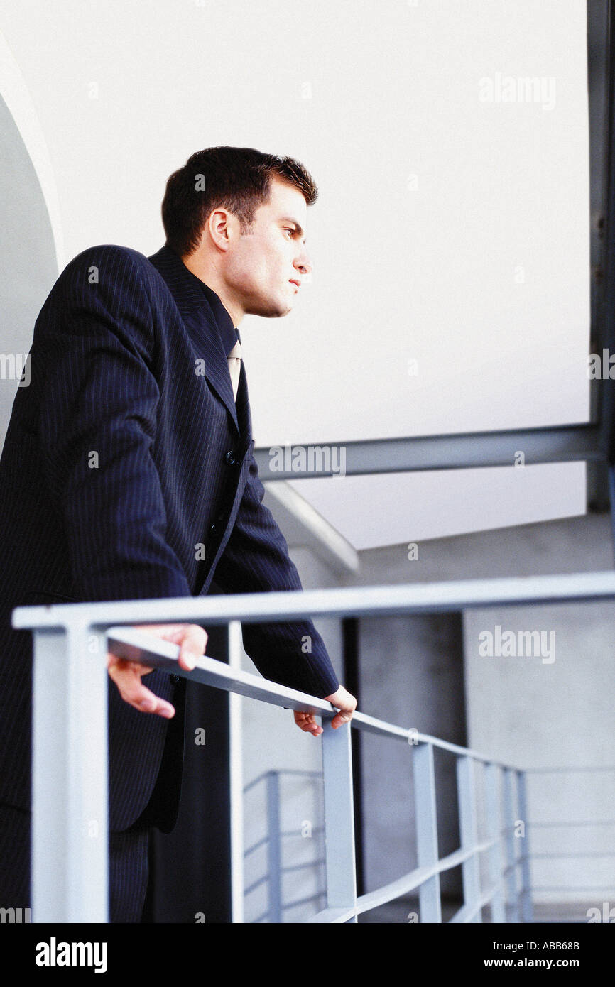 Man leaning on balustrade Stock Photo - Alamy