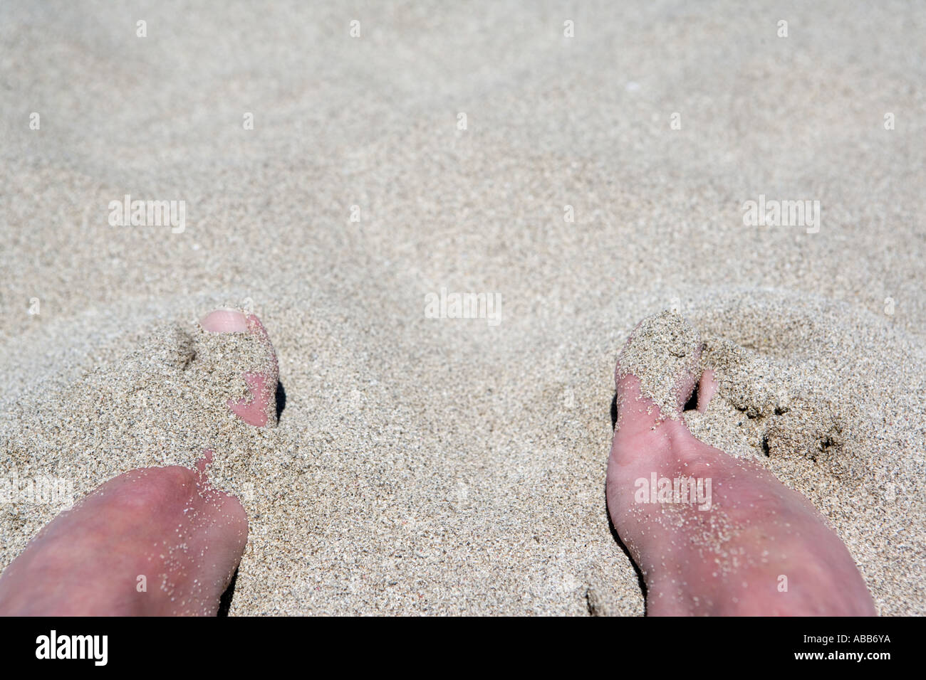 FEET IN SAND Stock Photo - Alamy