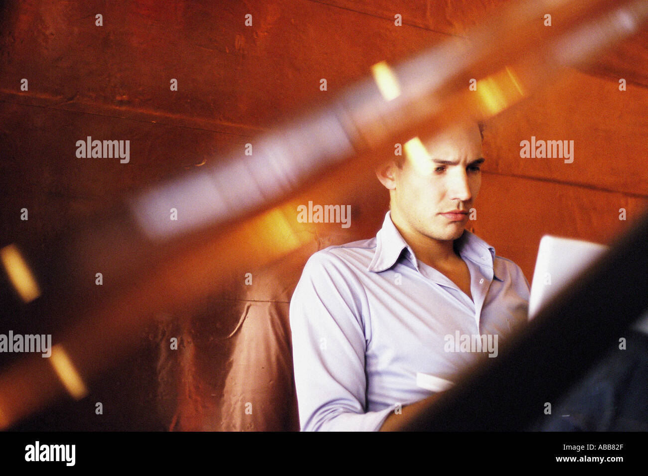 Man doing personal work in bar Stock Photo - Alamy