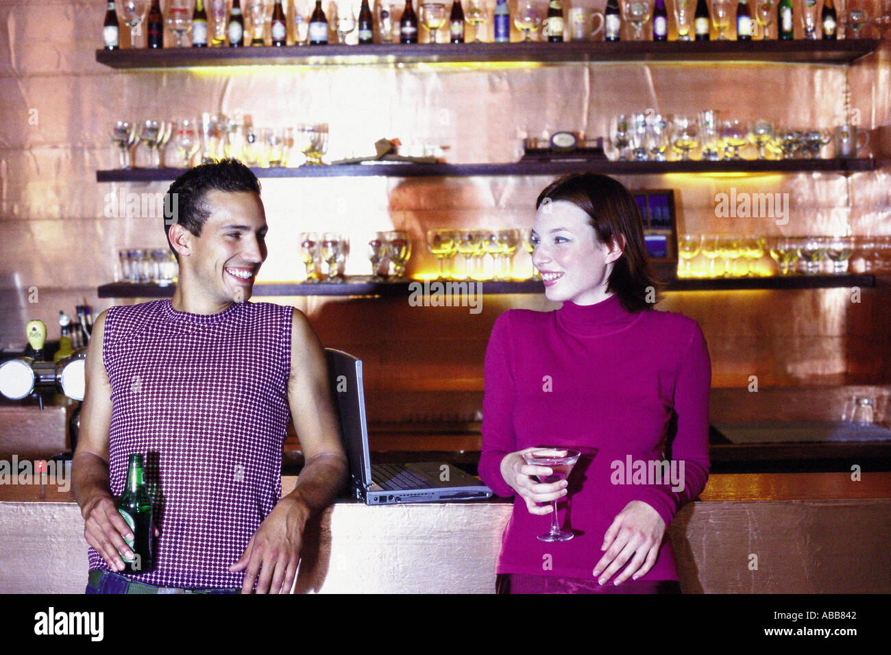 Man and woman having drink in bar Stock Photo - Alamy