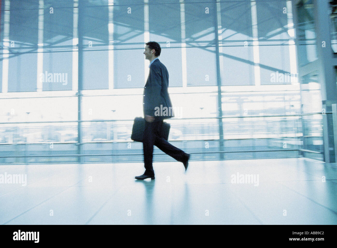 Businessman in airport terminal Stock Photo - Alamy