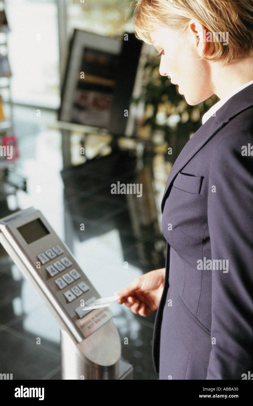 Businesswoman entering security pass Stock Photo - Alamy