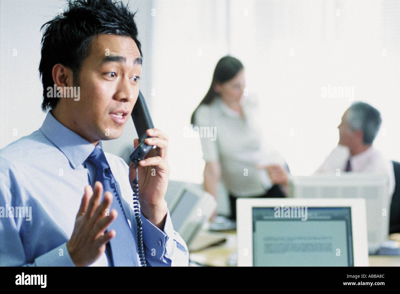 Businessman on telephone in office Stock Photo - Alamy